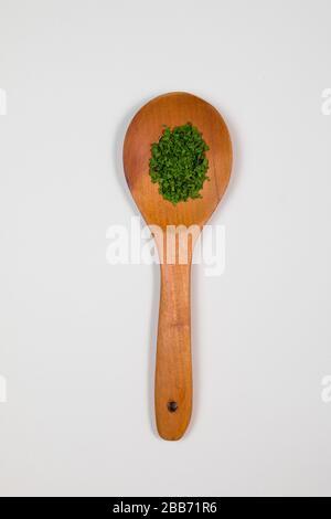 Wooden ladle with green herbs and spices Stock Photo - Alamy