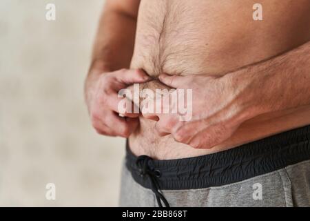 excess fat on the stomach of a young man Stock Photo - Alamy