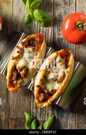 Delicious homemade cheesy pizza slice rustic round wooden board with ...