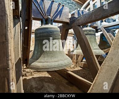 Traditional large old bells hanging in an english church tower from the ...