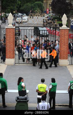 Stewards open the gates to let the crowd of spectators into the ground ...