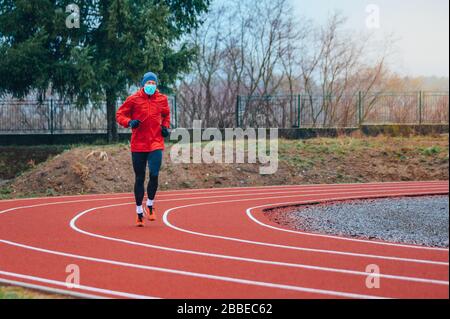 Runner wearing medical mask, Coronavirus pandemic Covid-19. Sport ...
