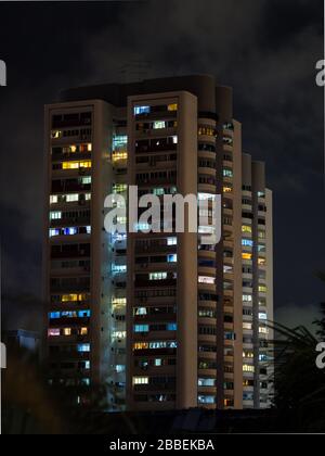 An apartment building at night with lighted windows Stock Photo - Alamy