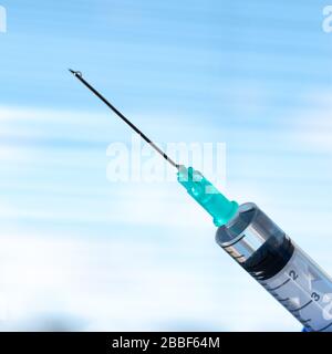 Syringe with needle on blur background Stock Photo - Alamy