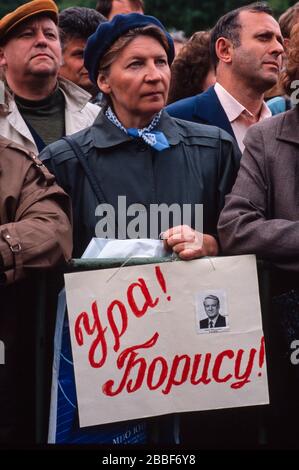 A middle-aged Russian woman, dressed in pink clothes and stiletto heels ...