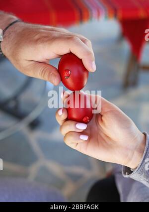 hands holding cracked red Easter eggs - Orthodox greek tradition of ...