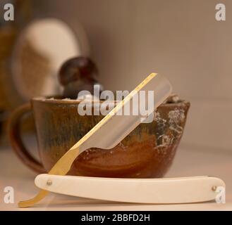 Shaving razor and foam in bowl - barber tools equipment Stock Photo - Alamy