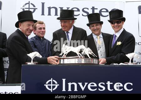 Owners John Magnier and Derrick Smith talk with jockey Seamus Heffernan ...
