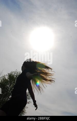 A silhouette of a woman twirling in the sun Stock Photo - Alamy