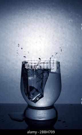 splashing from a glass when throwing ice cubes, vignetting Stock Photo ...