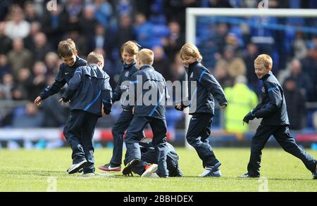 Everton mascots on the pitch Stock Photo - Alamy