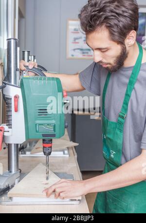 carpenter using electric drilling machine Stock Photo - Alamy