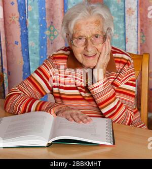 Senior citizen reading a book - cropped on a white background Stock ...