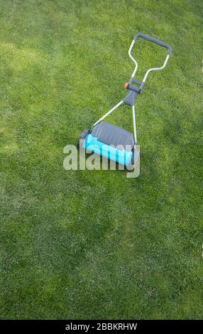 Lawnmover hand held machine. Hand lawn mower. Lawn mower on a green ...
