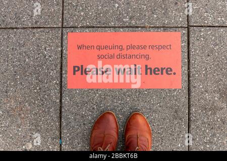 A close up view of taped off area on where to stand waiting to get into ...