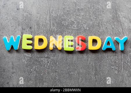 Wednesday word written with colorful letters on wooden table background ...