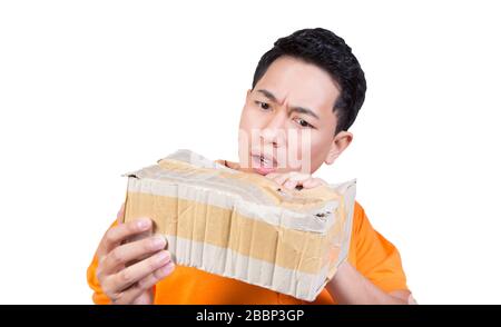 A delivery man holding a smashed package and looking apologetic Full ...