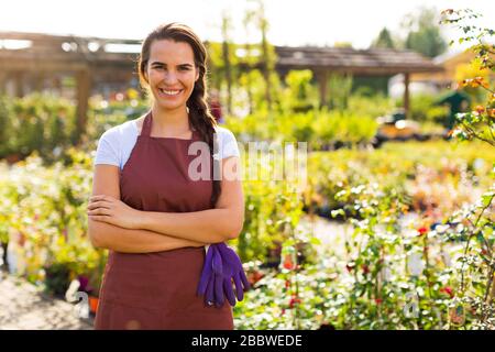 Smiling employees in garden center Stock Photo - Alamy