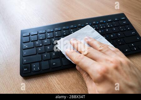 Man Wiping Computer Keyboard With Sanitizer Against Virus Infection ...