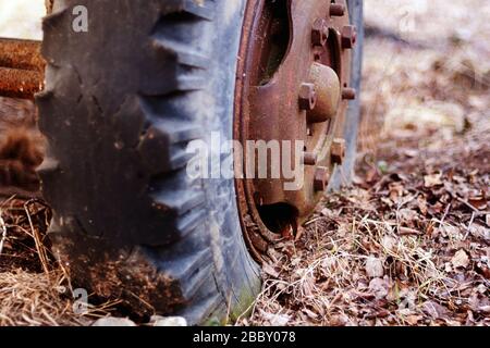 Old tractor tire with rusty wheel with corrosion Stock Photo - Alamy