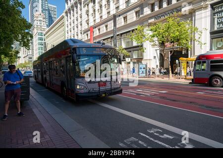 Muni bus Fulton line 5 on moving past person at bus stop Stock Photo ...