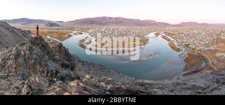 Woman standing on a rock overlooking the ocean on a misty morning Stock ...