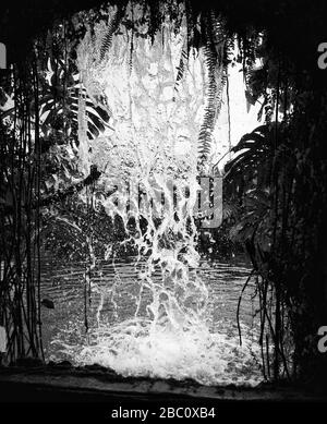Behind a waterfall from inside a cave at Port Mora on the coastal path ...