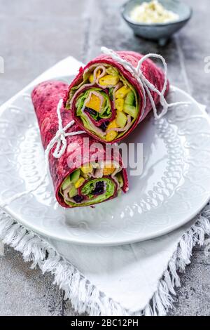 Beetroot wraps filled with ham, cheese, corn, iceberg lettuce ...