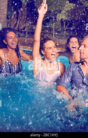 People splashing swimming and playing in the sea on the beach near ...