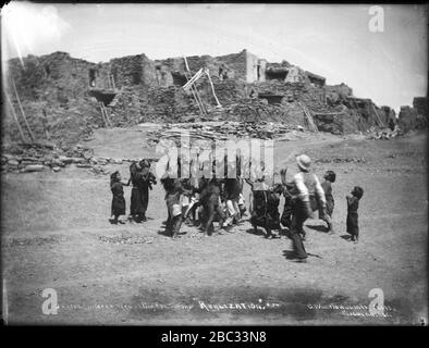 A group of twenty-two Hopi children lined up, waiting for candy, in ...