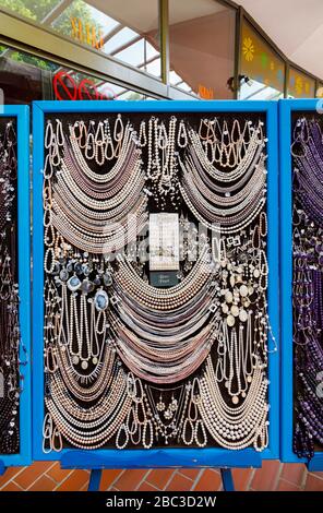 Colorful display of gemstone and pearl beads in varied shapes and sizes ...