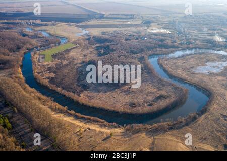 country forest river in early spring with no vegetation on the shores ...