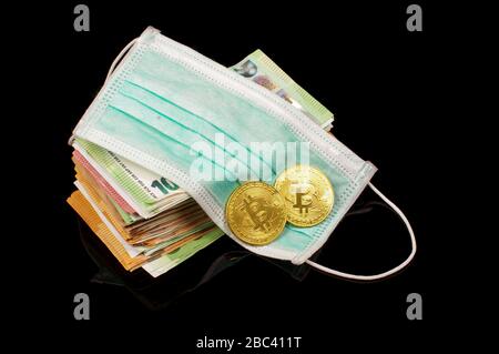 Bitcoin symbolic coin on the face mask and bunch of money banknotes ...