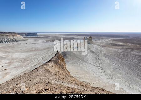 Man standing on plateau with panoramic view of rock formations, Ustyurt ...