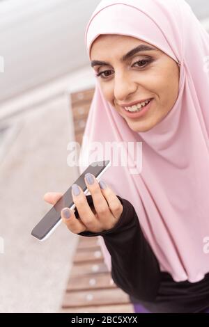 Woman communicating with a smartphone voice message from car passenger ...