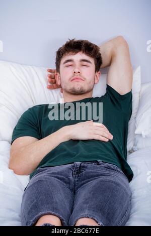 Joyful man sleeping on a bed in the clouds Stock Photo - Alamy