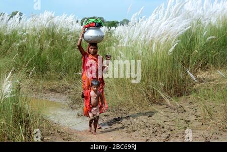 The mother carrying drinking water from far away with their children of ...