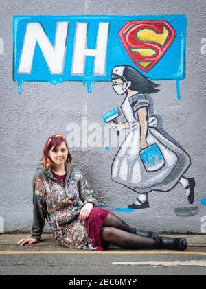 Artist Rachel List with her mural supporting the NHS on the gates of ...