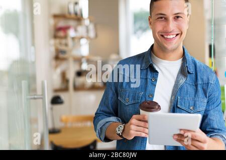 Young Man In Coffee Shop Talking On Mobile Phone Viewed Through Window ...