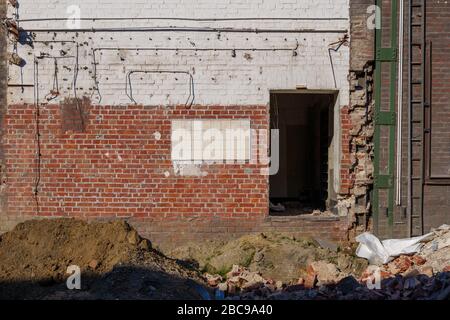 Side view of existing brick and tile wall, door and ruin of tile and ...