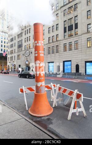 Con Edison red-and-white steam stacks vent steam vapor from below the ...