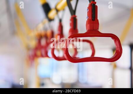 partially blurred grab handles for standing passengers in the passenger ...