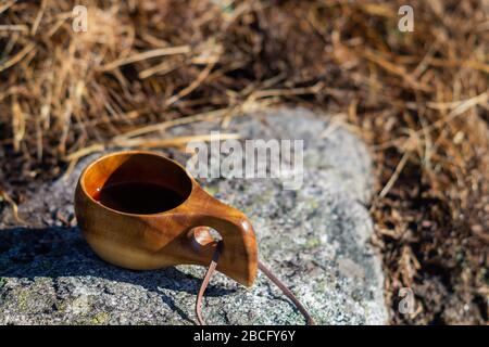 Wodden cup with coffee on a stone outdoors Stock Photo - Alamy