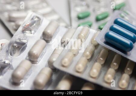 pill packs with colorful medicaments lying on the white background ...