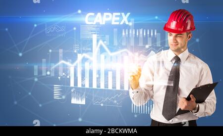 Handsome businessman with helmet drawing CAPEX inscription ...