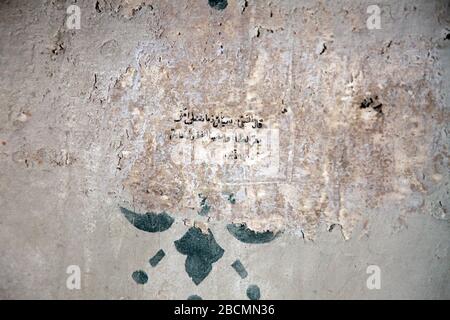 Prayer leader (imam) showing old Arabic graffiti at Arap Mosque in ...