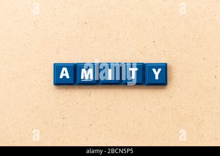 Tile alphabet letter with word goodwill in red color rack on wood ...