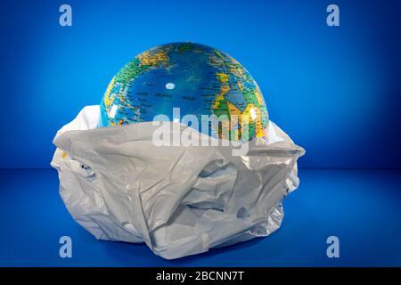 Plastic with earth inside and some trash. Earth is being destroyed ...