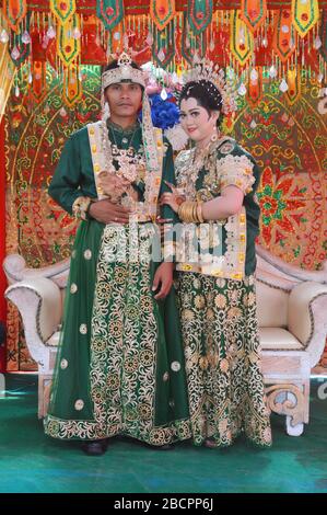 A couple in traditional Bugis dress in a tunnel. Bugis is one of the ...