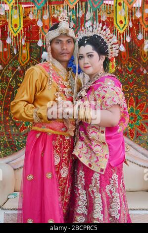 A couple in traditional Bugis dress in a tunnel. Bugis is one of the ...